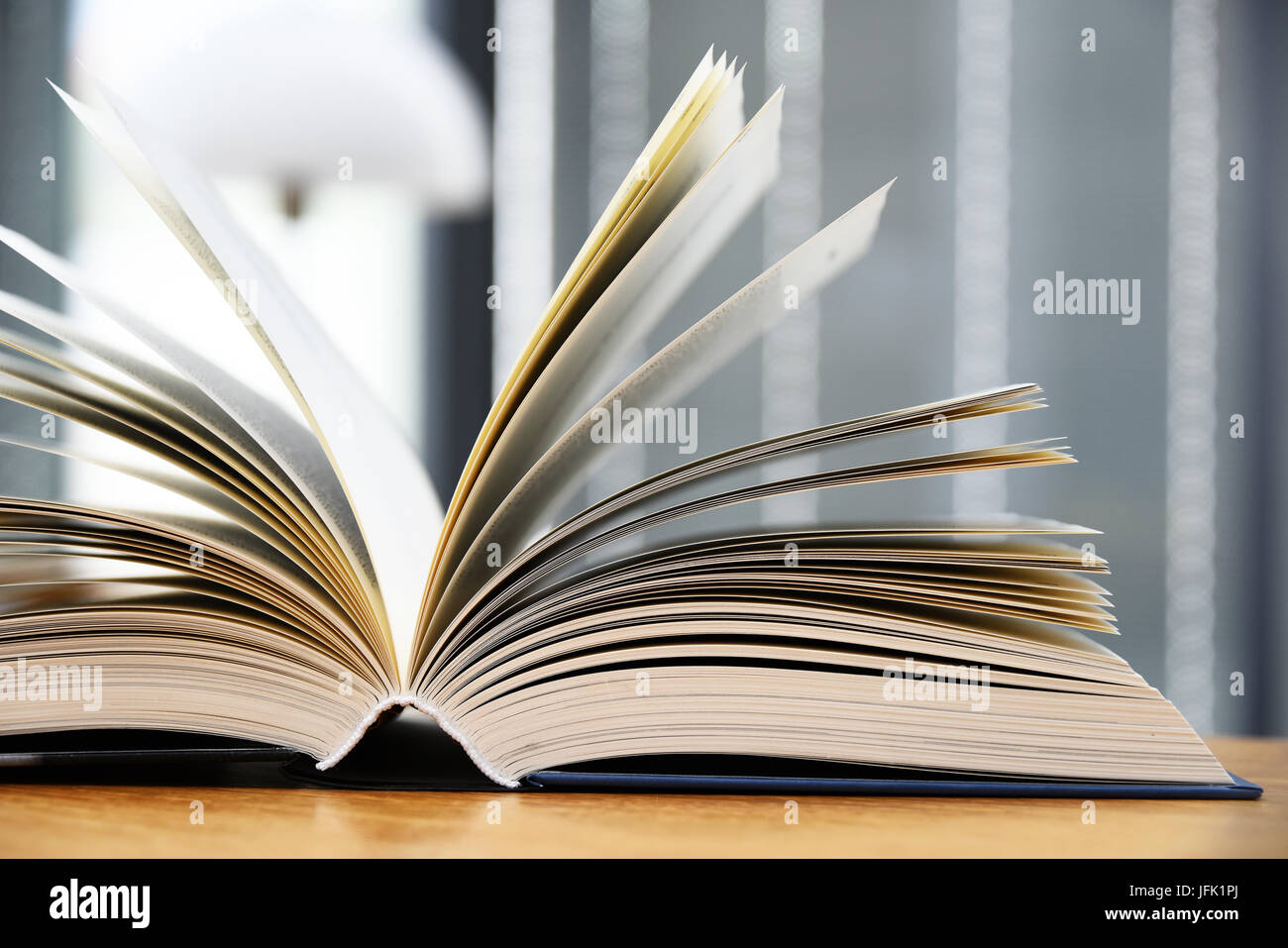 Hardcover book lying on the table in a library Stock Photo - Alamy