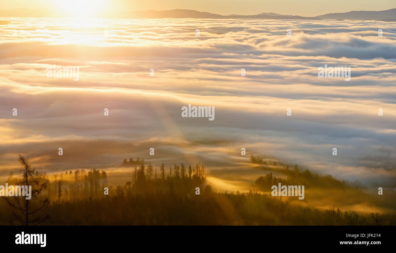 Clouds illuminated by morning sun over valley Stock Photo - Alamy