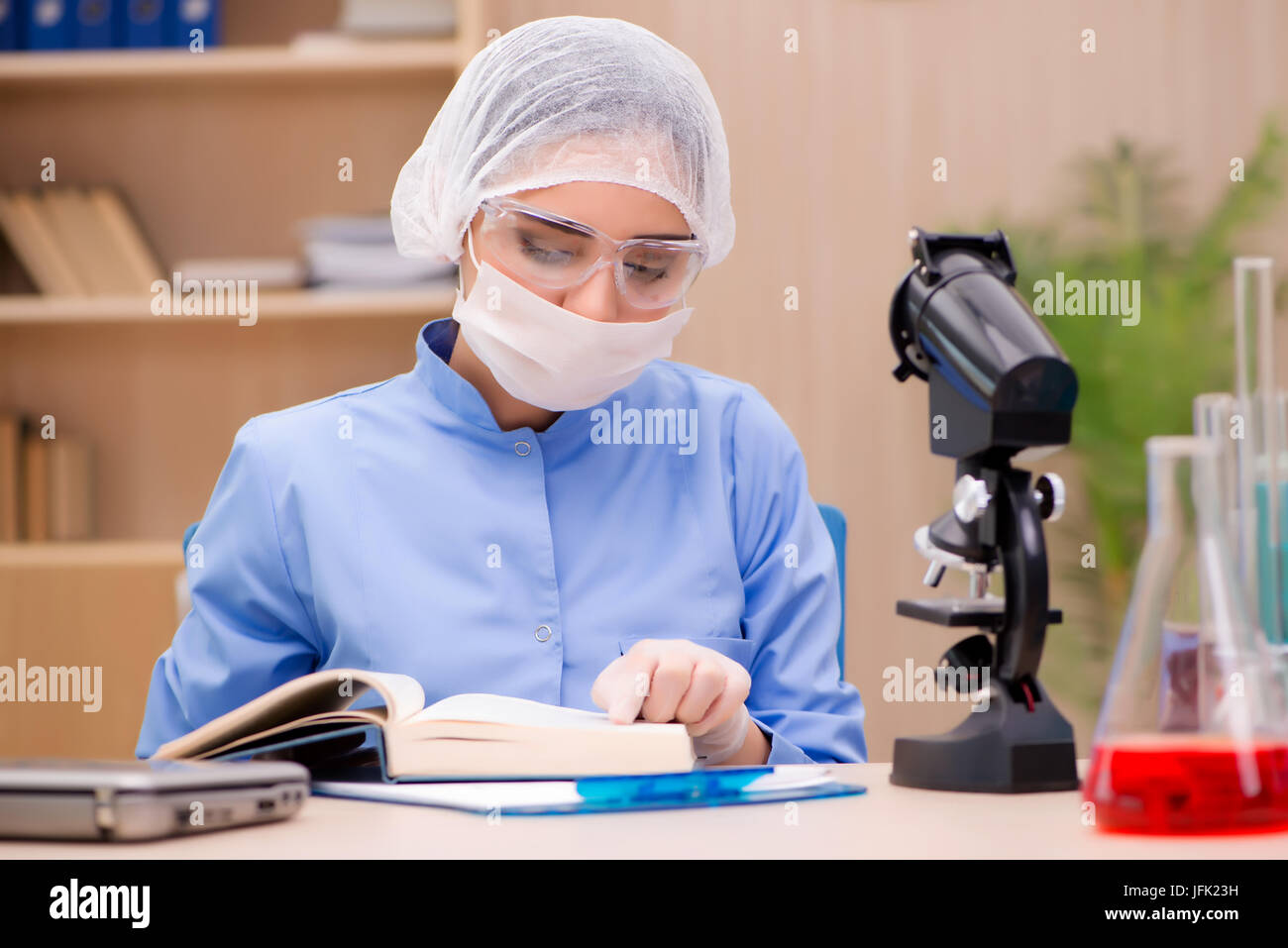 Lab chemist working with microscope and tubes Stock Photo - Alamy