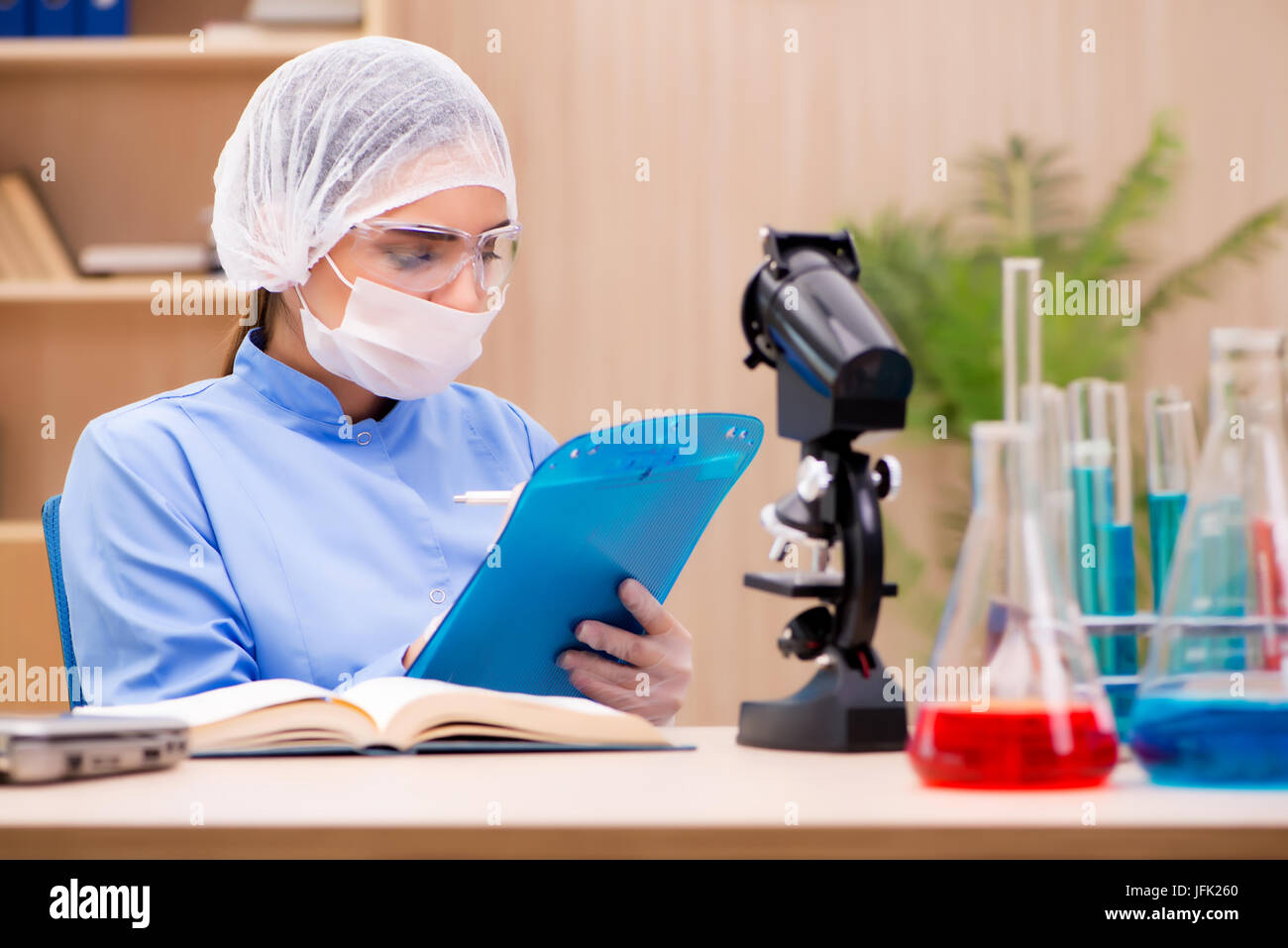 Lab chemist working with microscope and tubes Stock Photo - Alamy