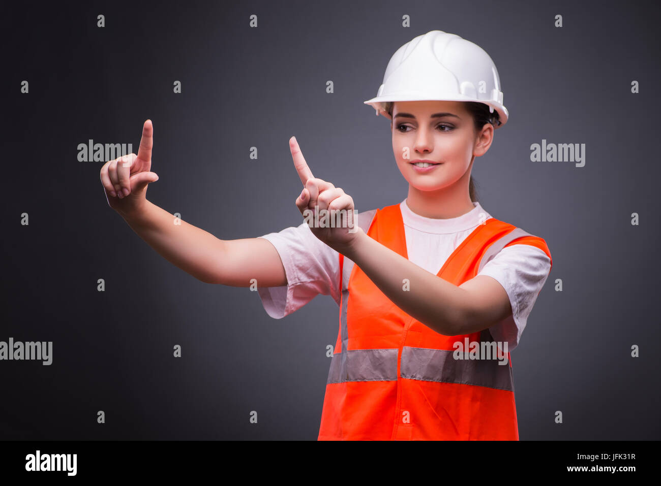 Cute construction worker pressing virtual buttons Stock Photo - Alamy