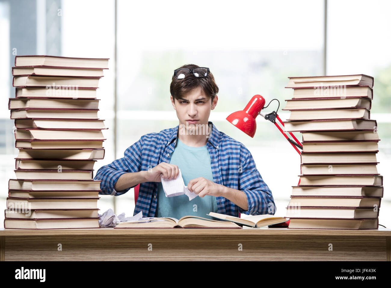 Student with lots of books preparing for exams Stock Photo - Alamy