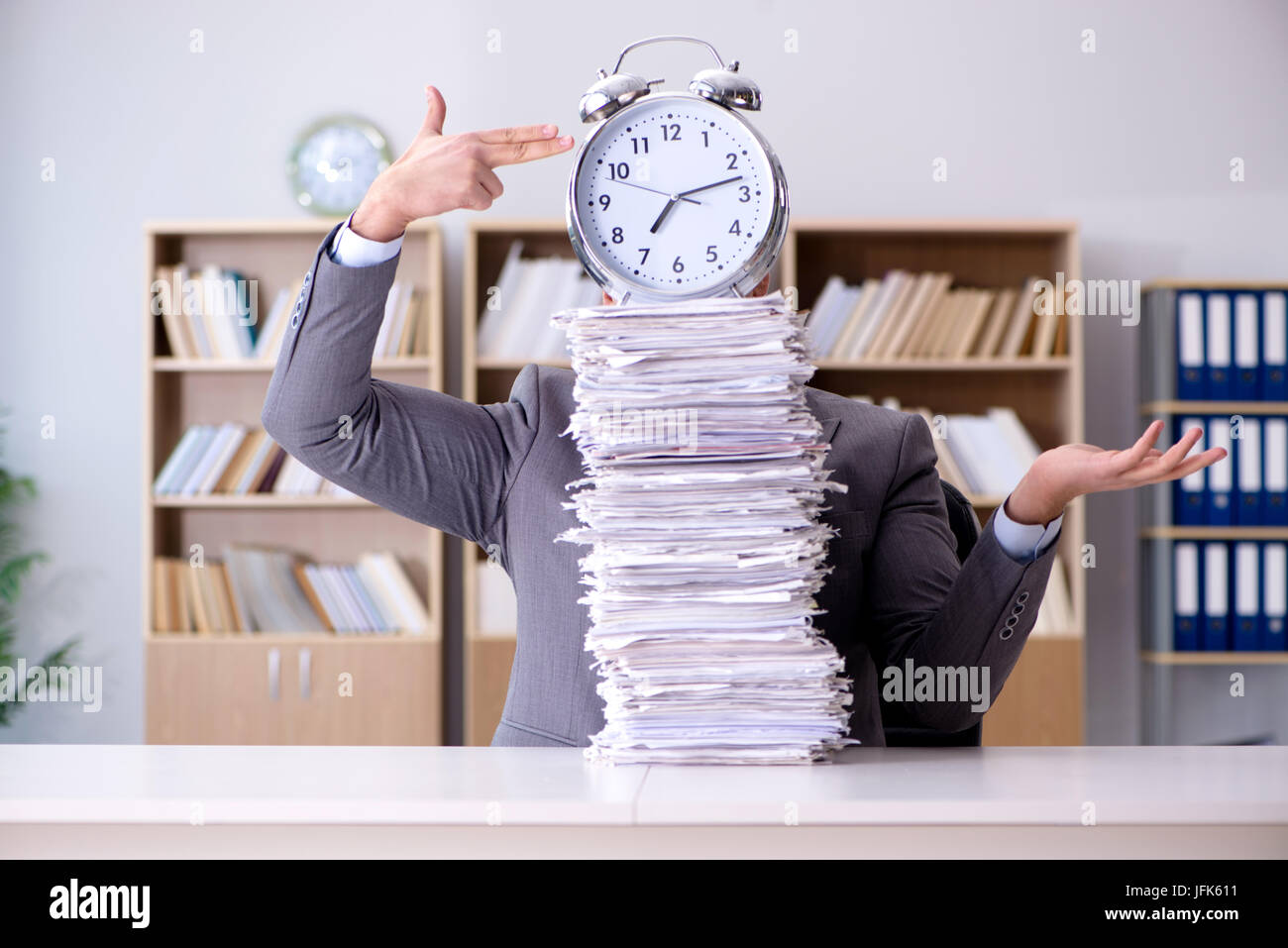 Businessman struggling to meet challenging deadlines Stock Photo - Alamy