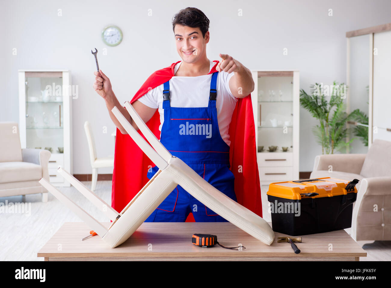 Superhero repairman with tools in repair concept Stock Photo - Alamy