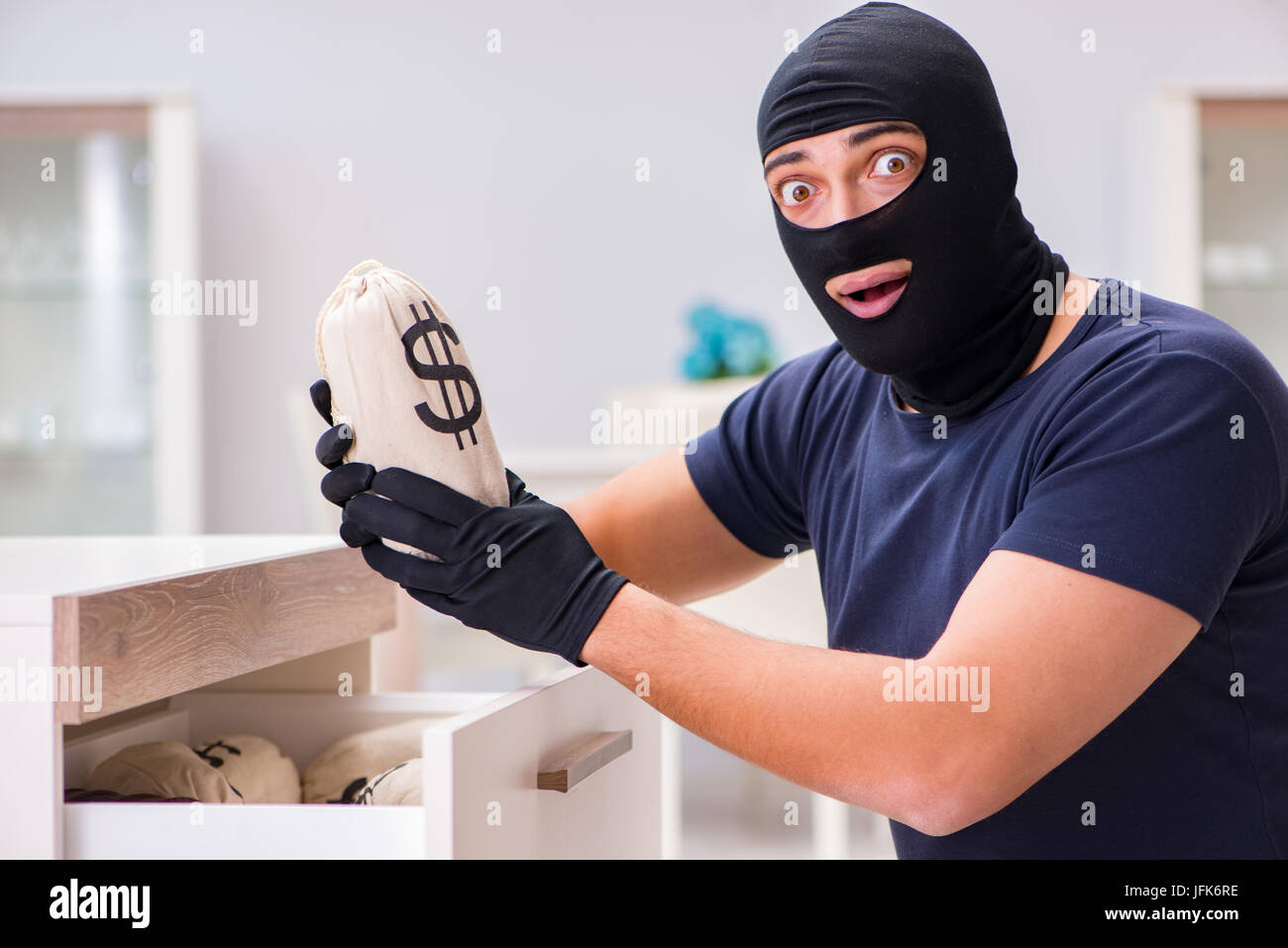 Robber wearing balaclava stealing valuable things Stock Photo - Alamy
