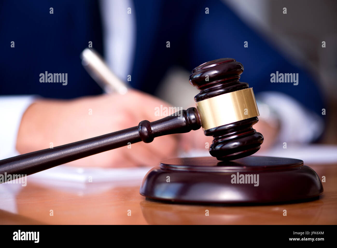 Handsome judge with gavel sitting in courtroom Stock Photo - Alamy