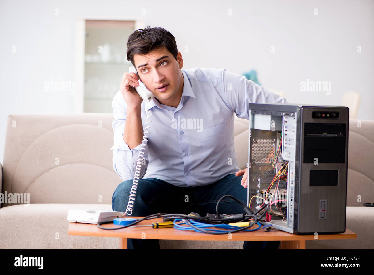 Angry customer trying to repair computer with phone support Stock Photo ...