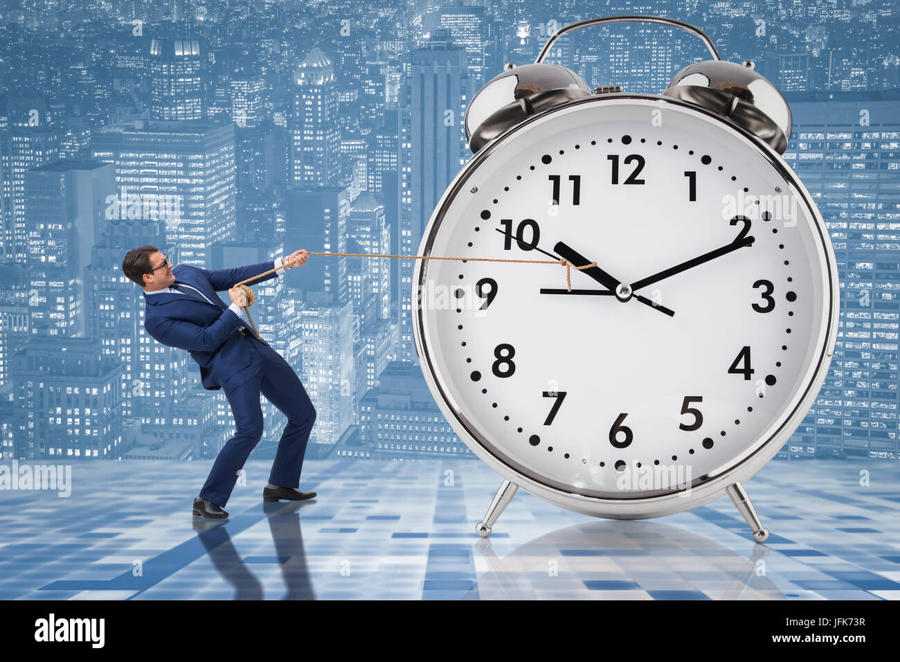 Businessman pulling clock in time management concept Stock Photo - Alamy