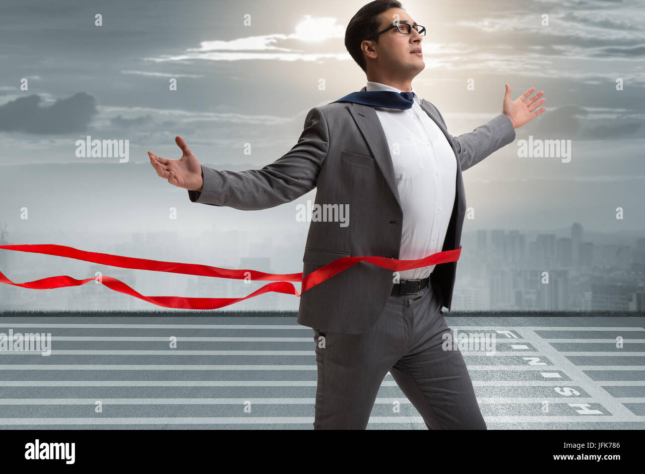 Businessman on the finishing line in competition concept Stock Photo ...