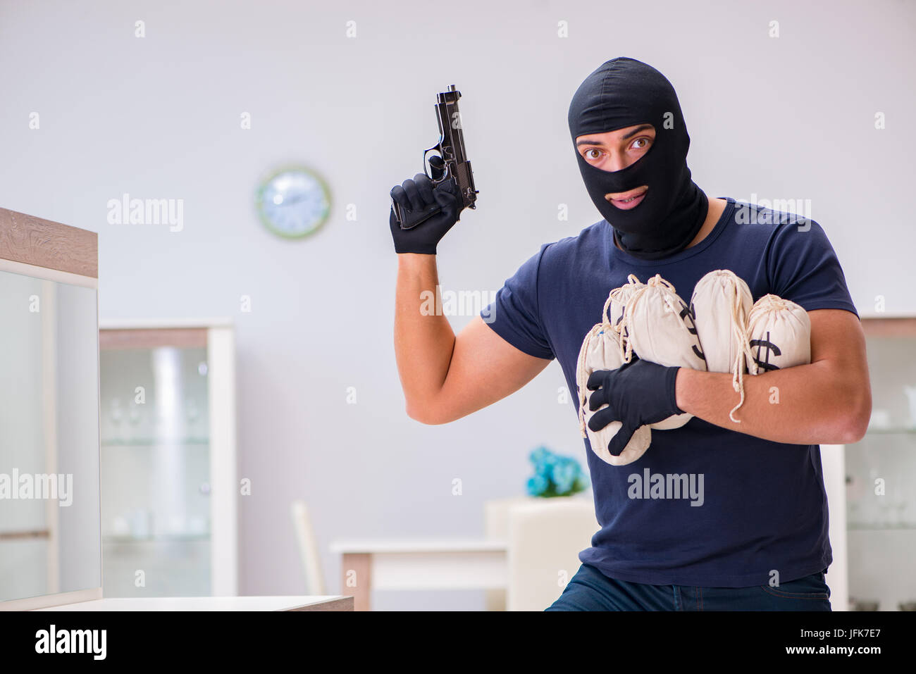 Robber wearing balaclava stealing valuable things Stock Photo - Alamy