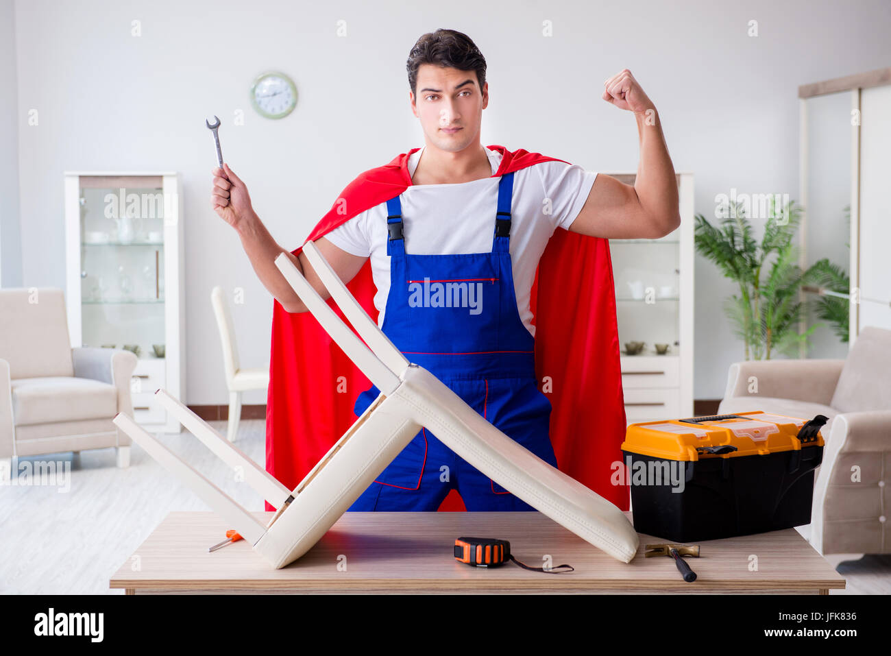 Superhero repairman with tools in repair concept Stock Photo - Alamy