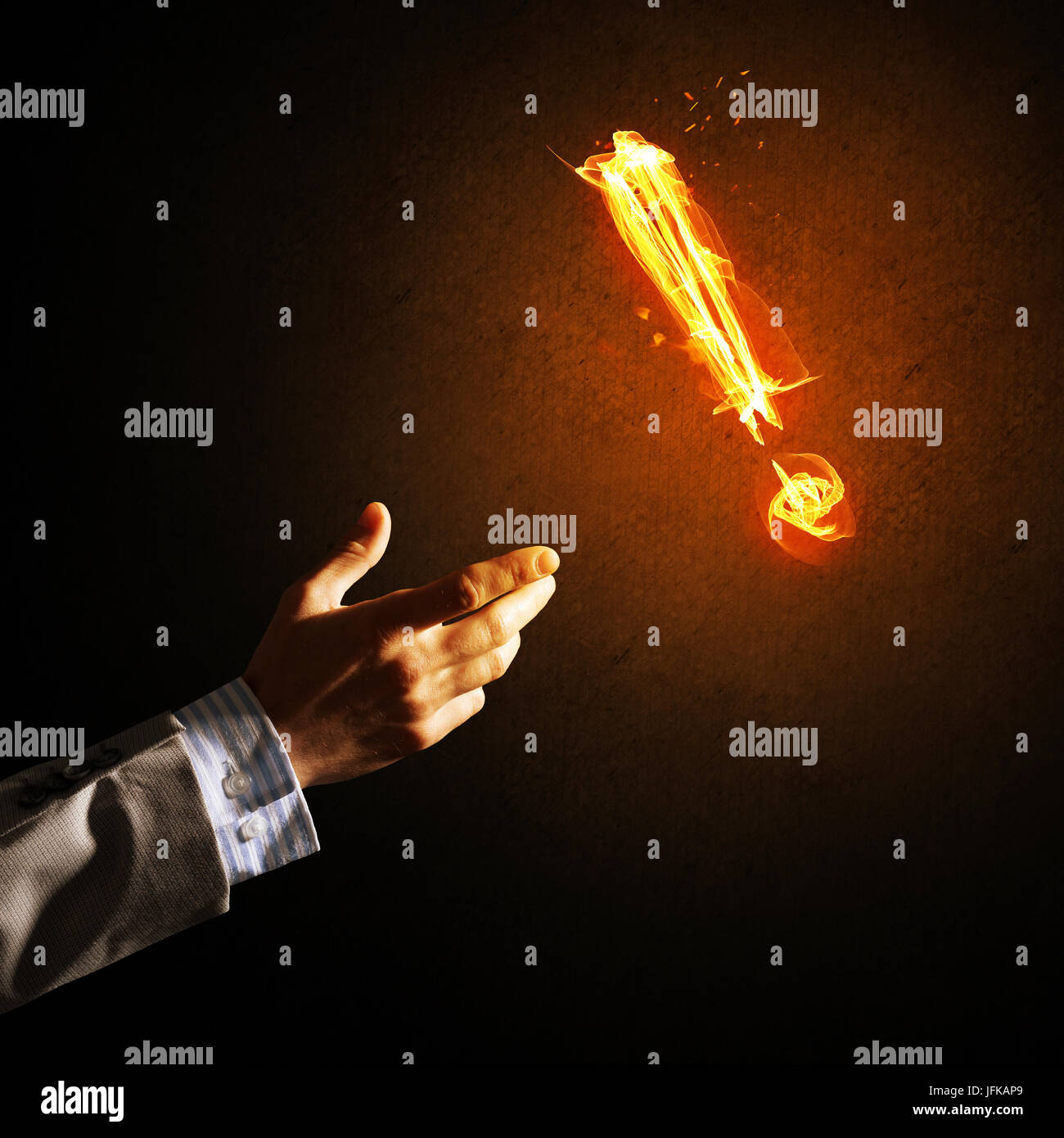 Businessman hand and fire glowing exclamation mark Stock Photo - Alamy