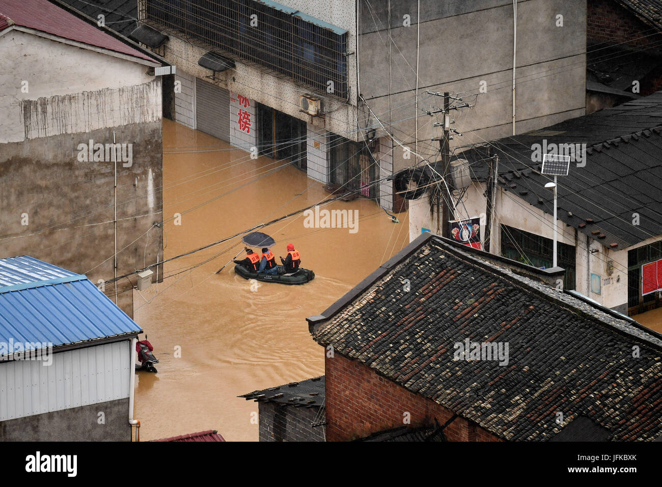Changsha. 1st July, 2017. Rescuers search for trapped persons at a ...