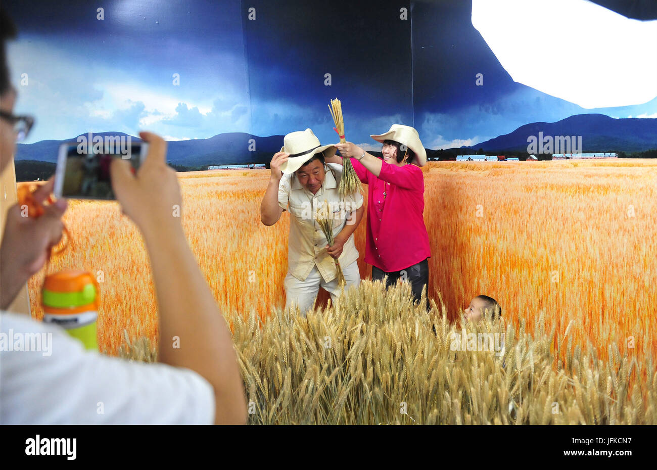 Beijing, China. 1st July, 2017. Visitors pose for photos during a photo ...
