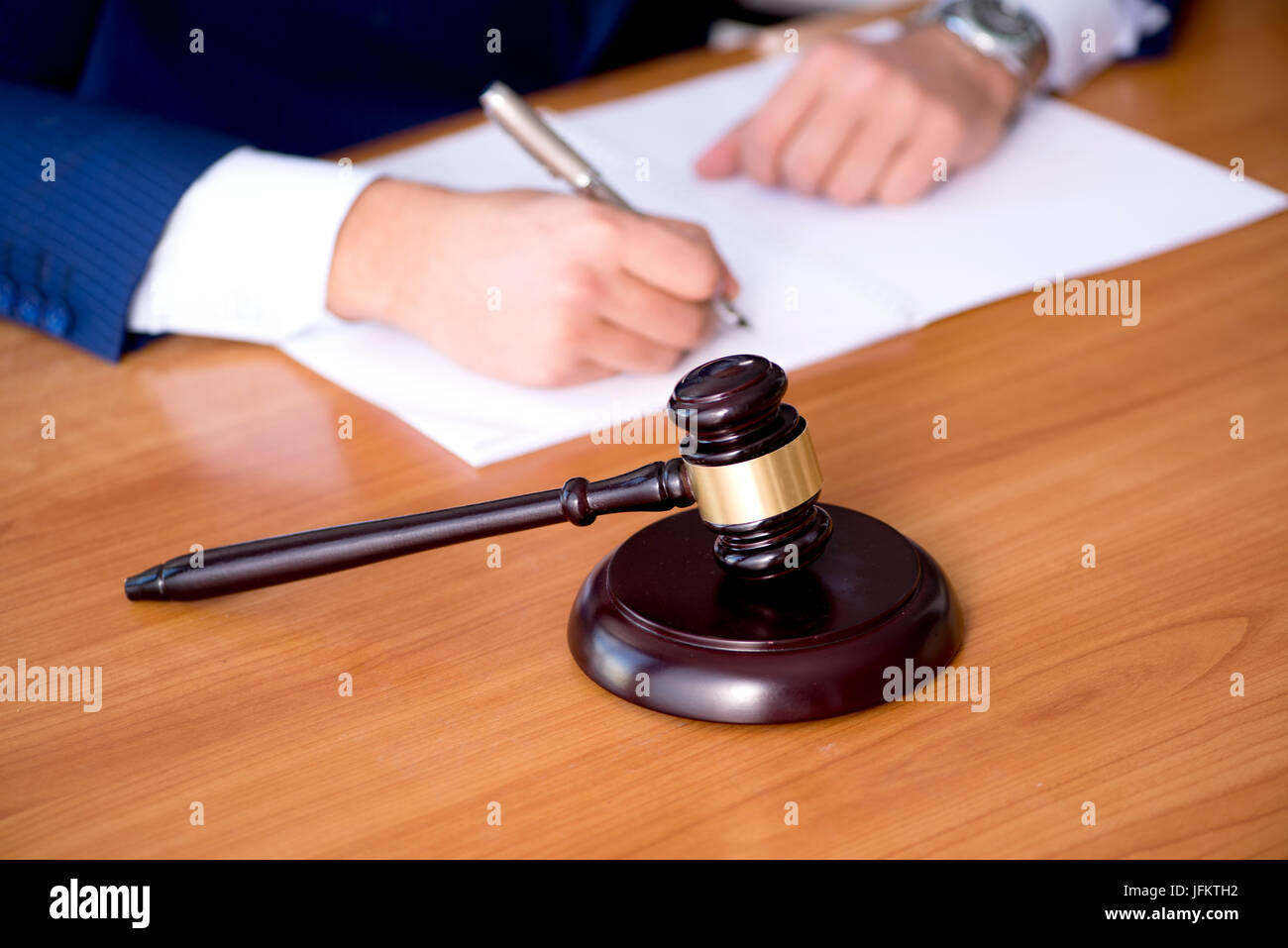 Handsome judge with gavel sitting in courtroom Stock Photo - Alamy