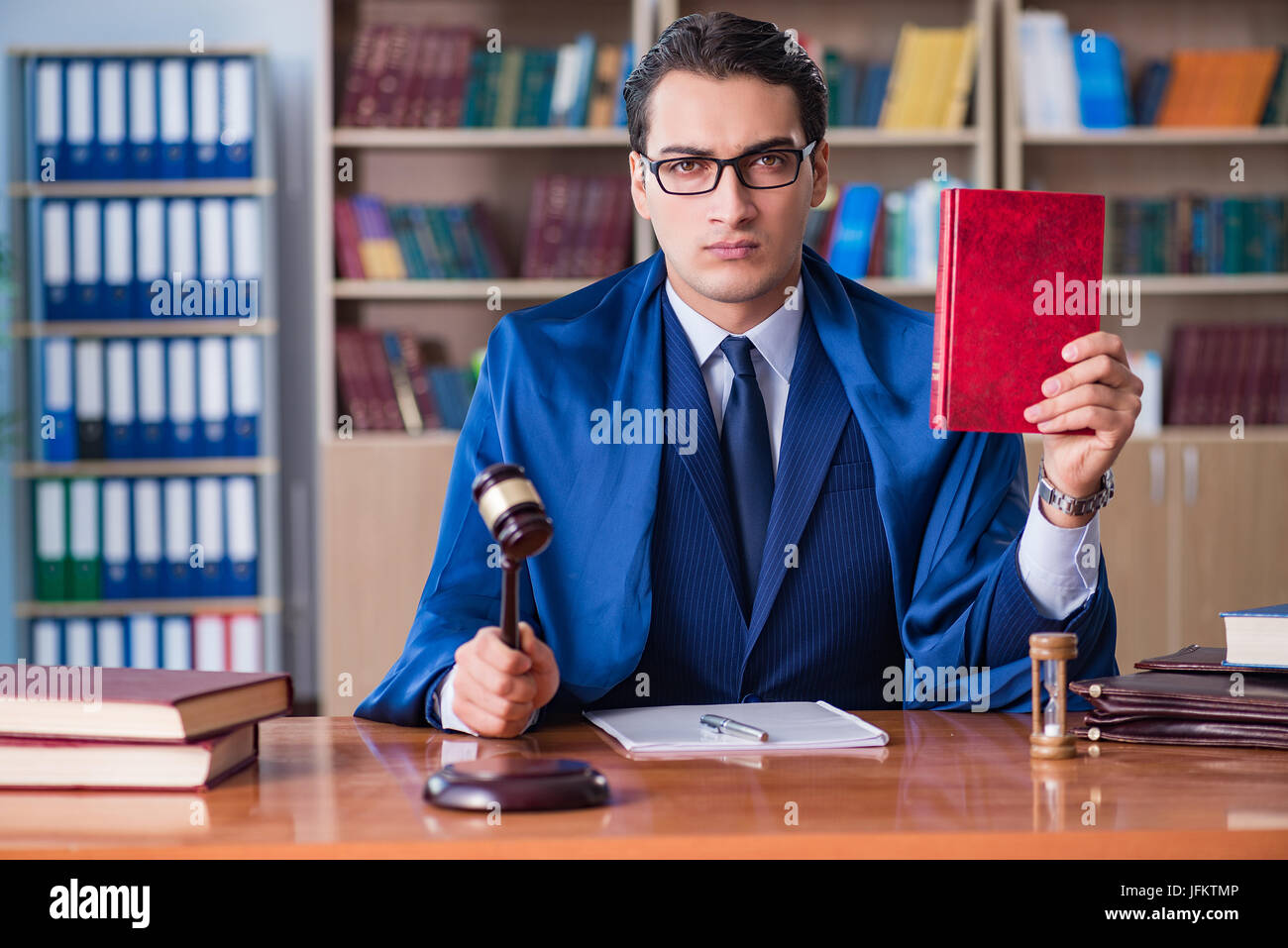 Handsome judge with gavel sitting in courtroom Stock Photo - Alamy
