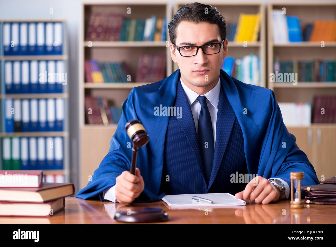 Handsome judge with gavel sitting in courtroom Stock Photo - Alamy