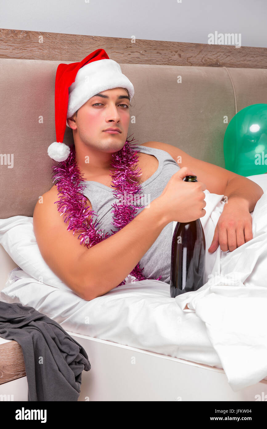 Young man having hangover after heavy partying Stock Photo - Alamy
