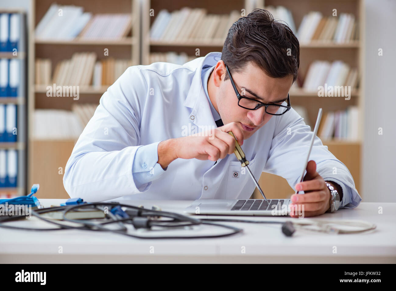 IT technician repairing broken laptop notebook computer Stock Photo - Alamy