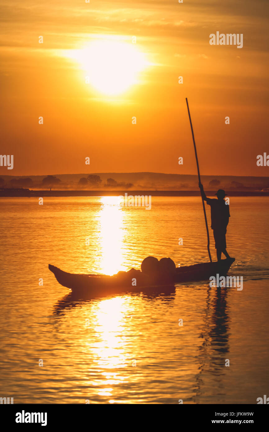 Pirogue at sunset Stock Photo - Alamy