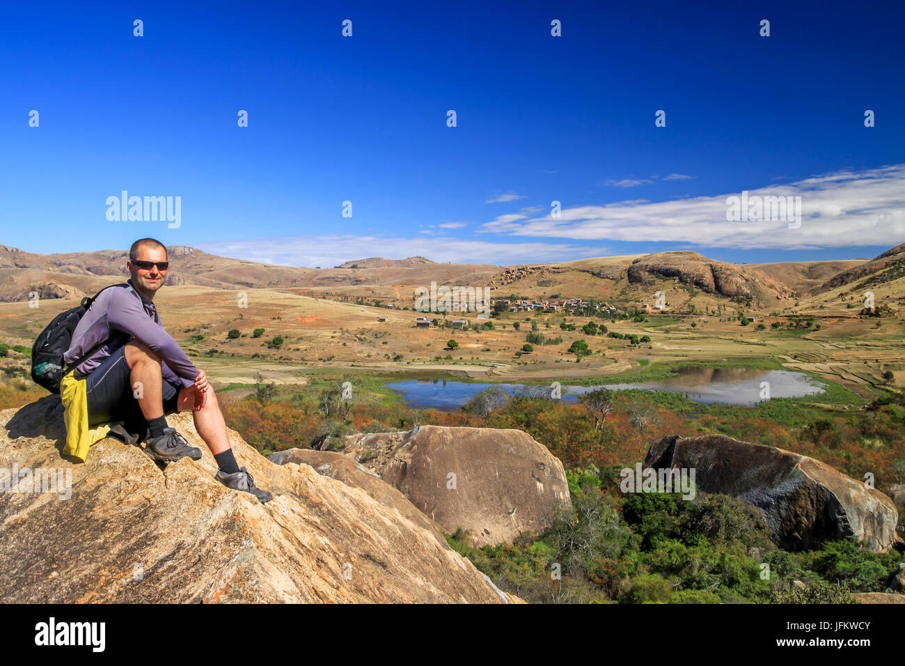 Man sitting on the rock Stock Photo - Alamy