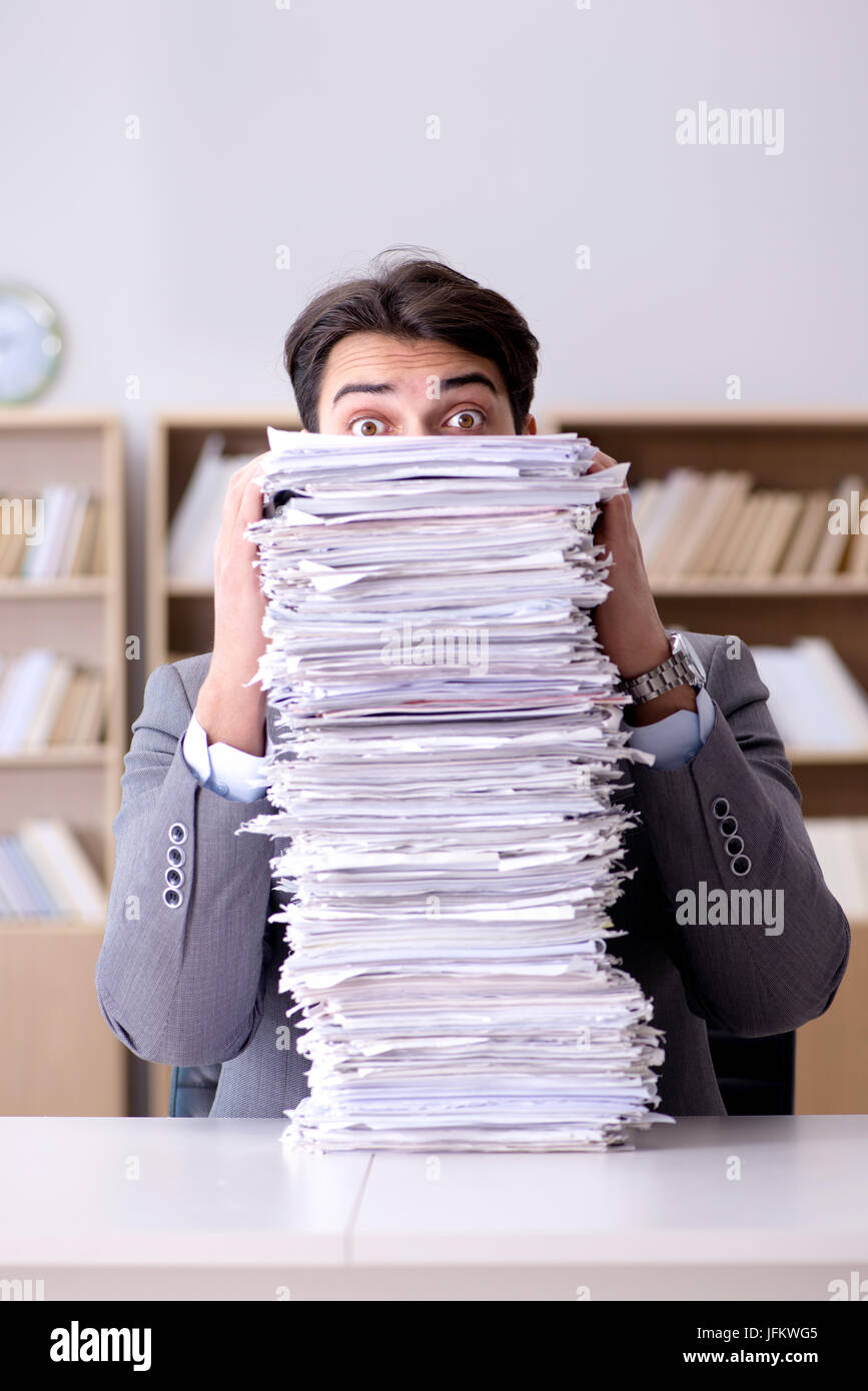 Businessman struggling to meet challenging deadlines Stock Photo - Alamy