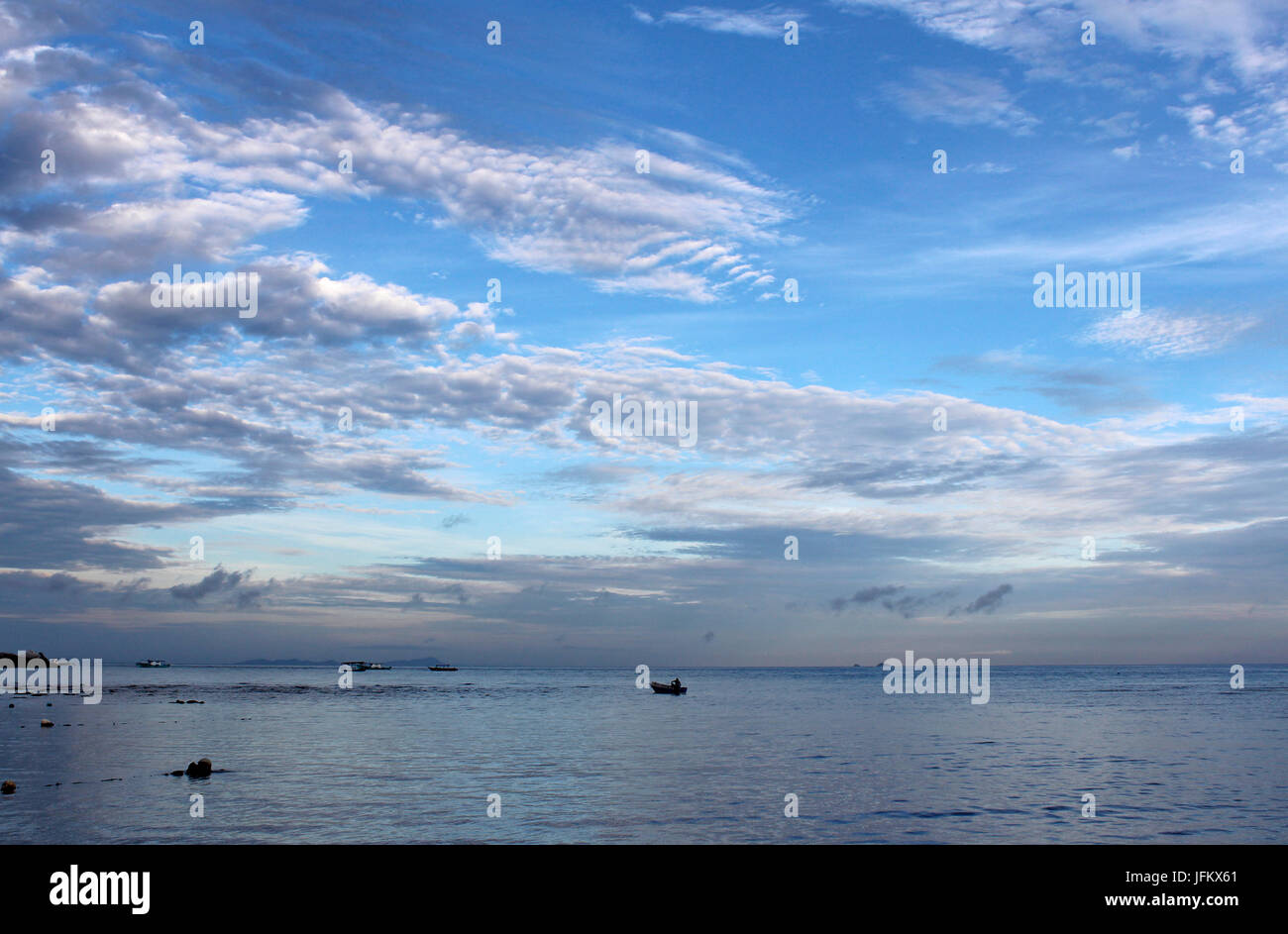 View of dawn at the seaside with a man on the boat, Tioman Island Stock ...