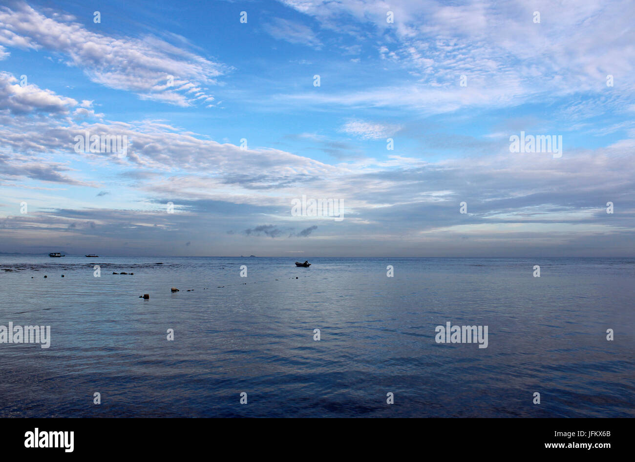 View of dawn at the seaside with a man on the boat, Tioman Island Stock ...