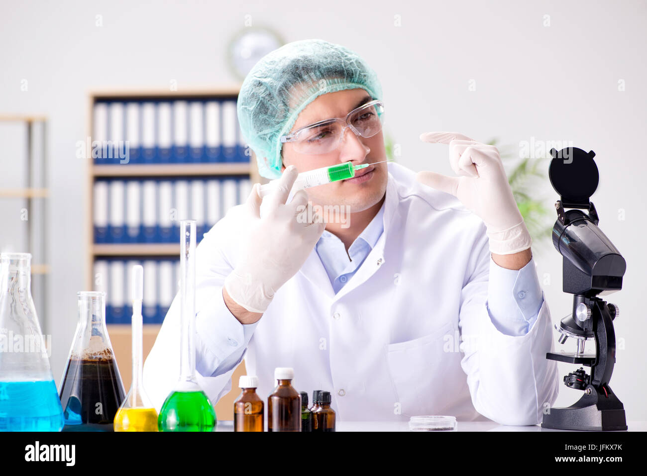 Young doctor working in the lab with microscope Stock Photo - Alamy