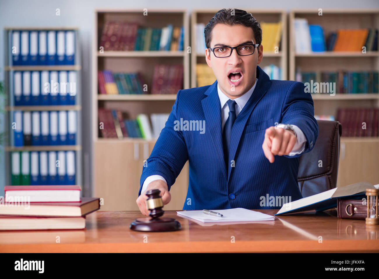 Handsome judge with gavel sitting in courtroom Stock Photo - Alamy