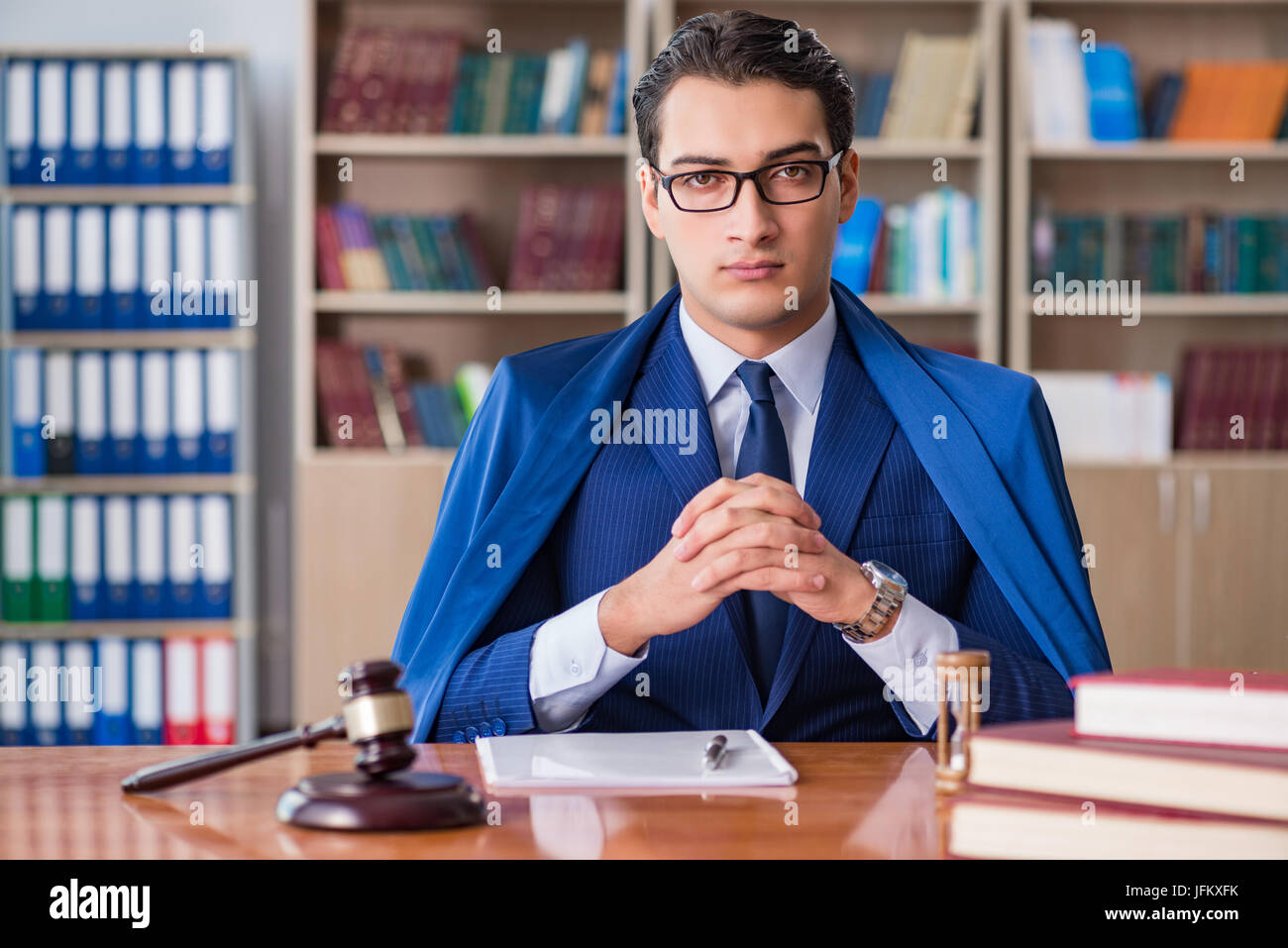 Handsome judge with gavel sitting in courtroom Stock Photo - Alamy