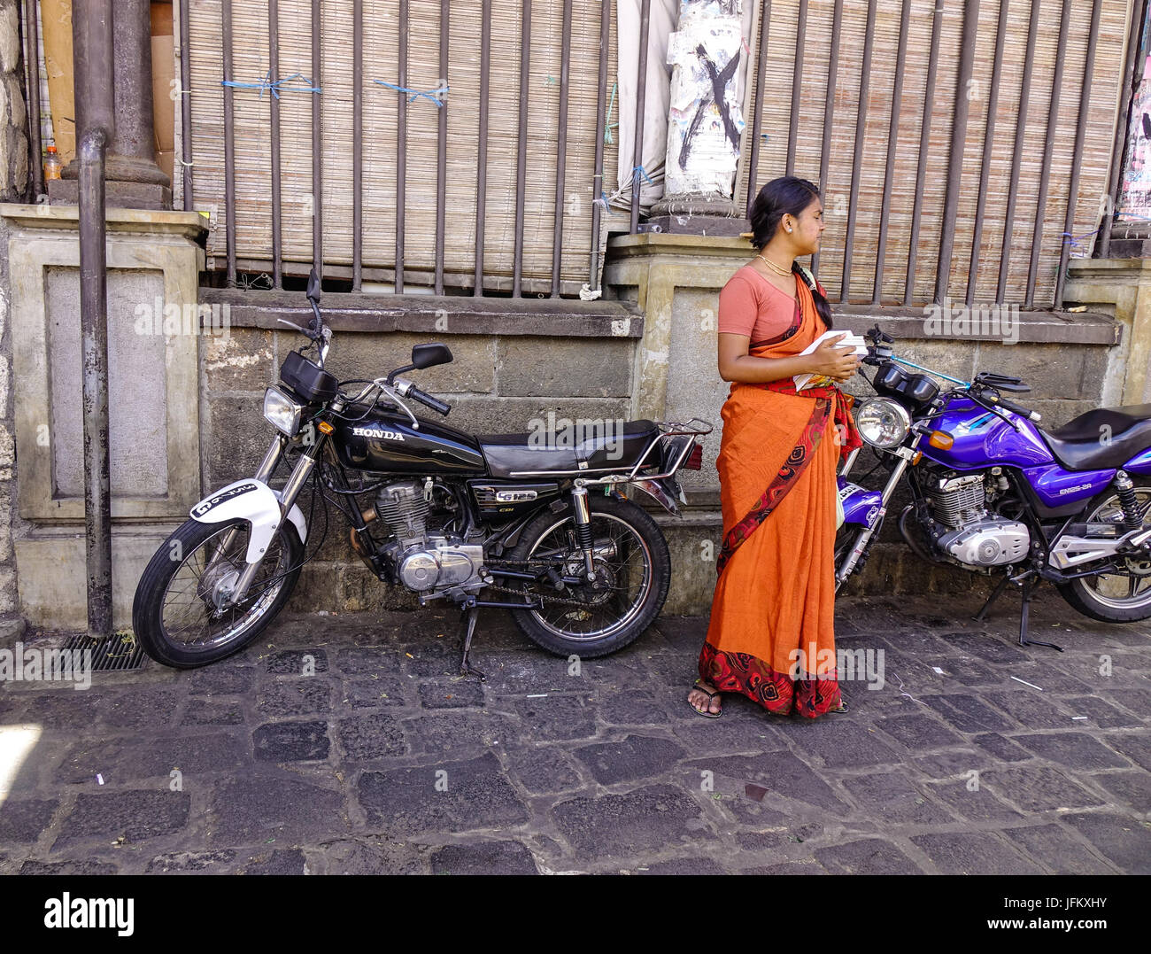 Port Louis, Mauritius - Jan 14, 2017. A woman standing on street in ...