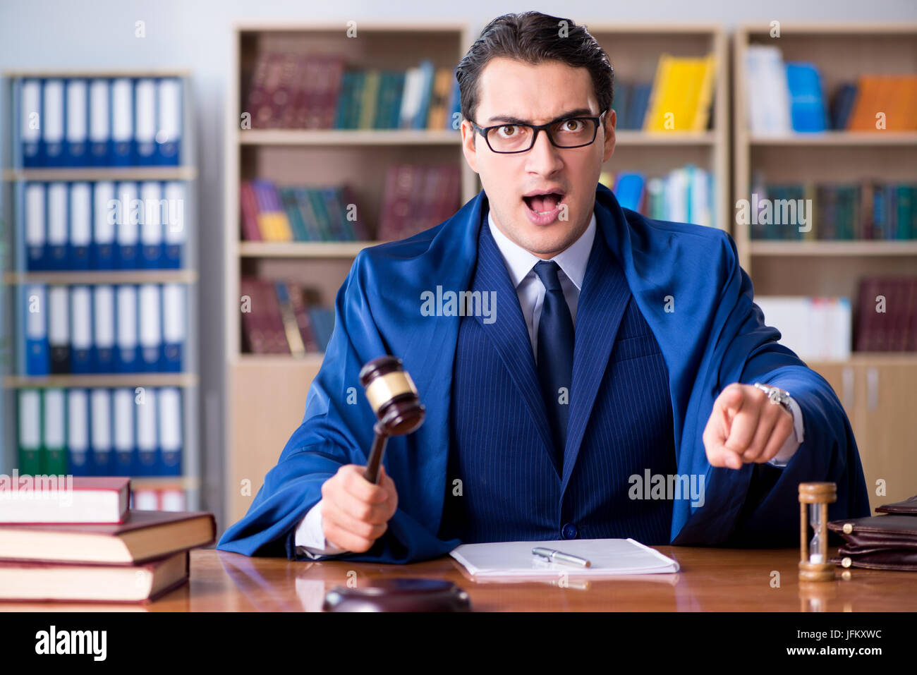 Handsome judge with gavel sitting in courtroom Stock Photo - Alamy