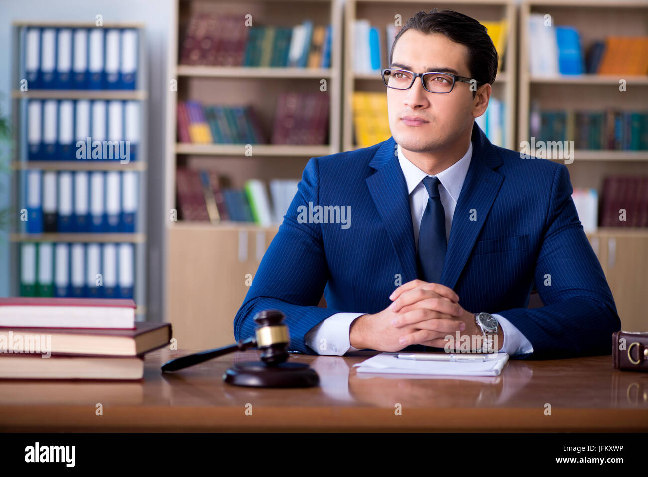 Handsome judge with gavel sitting in courtroom Stock Photo - Alamy