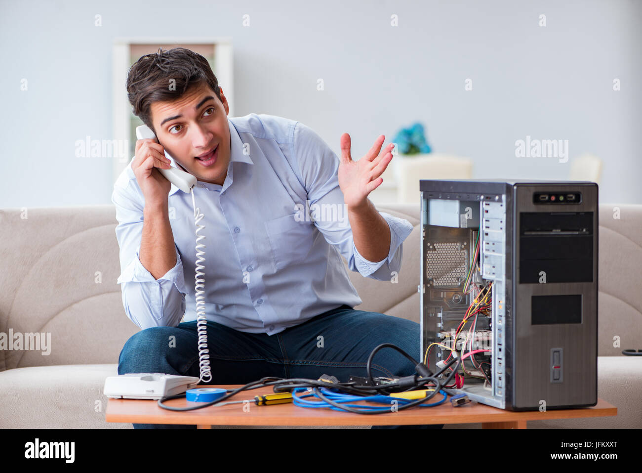 Angry customer trying to repair computer with phone support Stock Photo ...