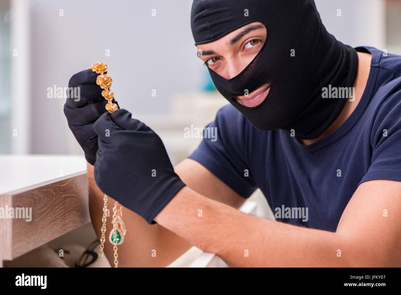 Robber wearing balaclava stealing valuable things Stock Photo - Alamy