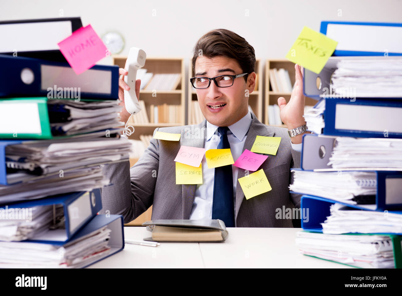 Businessman struggling with multiple priorities Stock Photo - Alamy