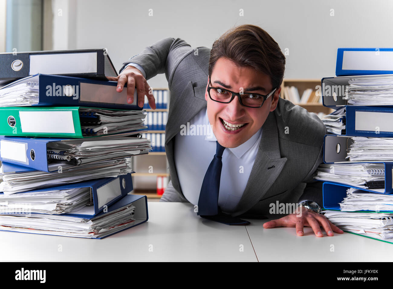 Businessman under stress due to excessive work Stock Photo - Alamy