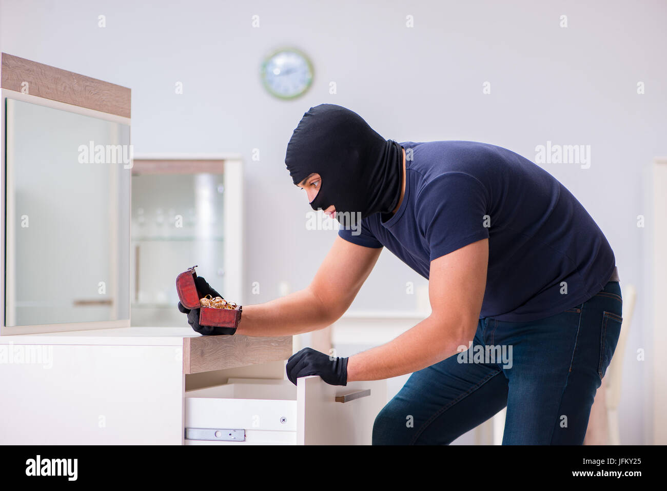 Robber wearing balaclava stealing valuable things Stock Photo - Alamy
