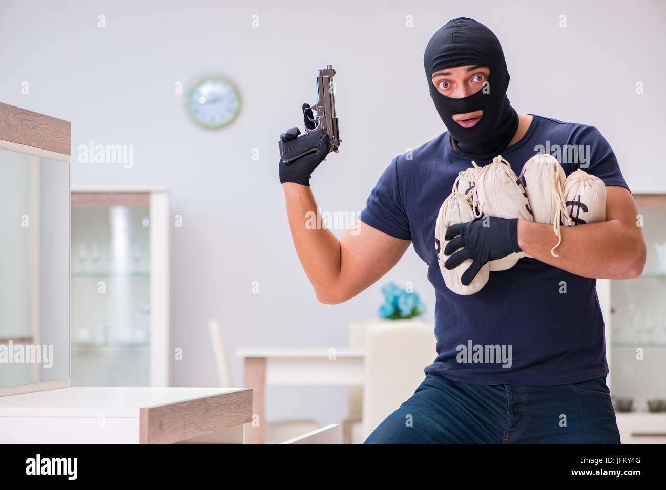 Robber wearing balaclava stealing valuable things Stock Photo - Alamy
