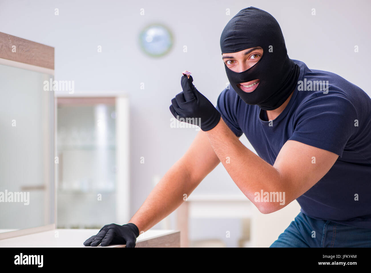 Robber wearing balaclava stealing valuable things Stock Photo - Alamy
