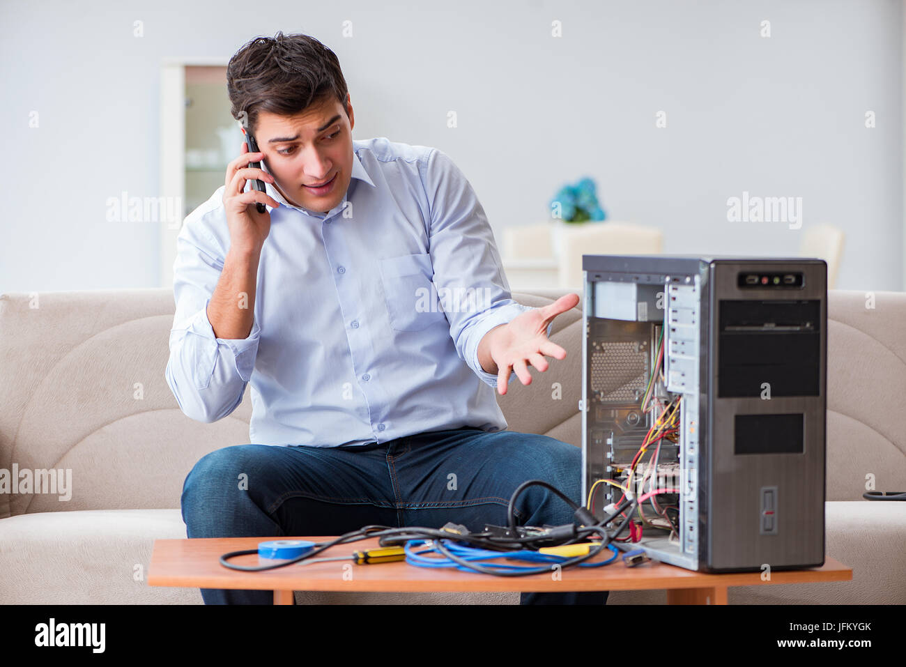 Angry customer trying to repair computer with phone support Stock Photo ...
