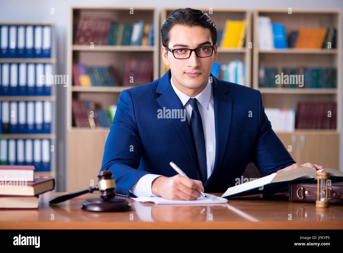 Handsome judge with gavel sitting in courtroom Stock Photo - Alamy