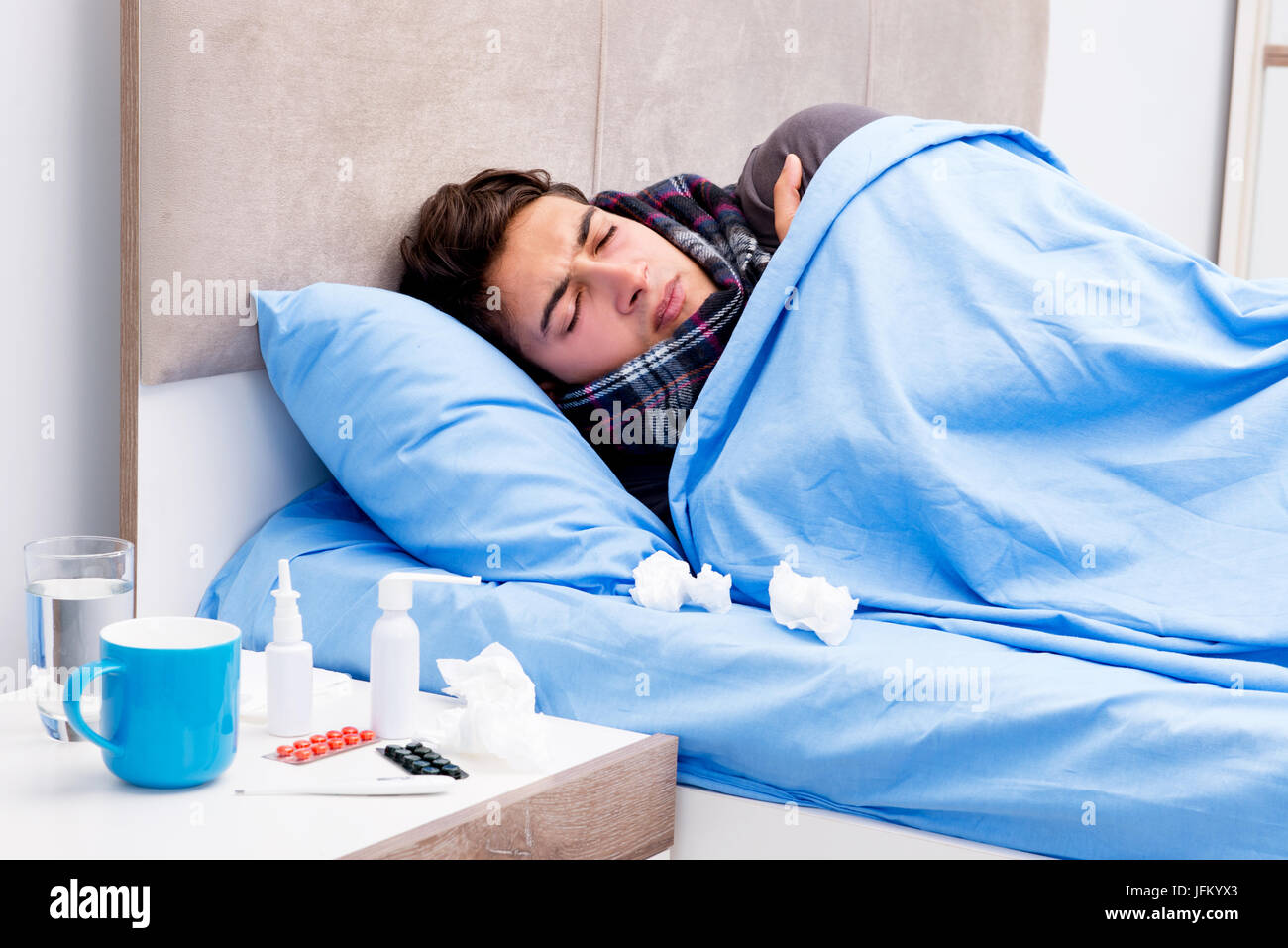 Sick ill man in the bed taking medicines and drugs Stock Photo - Alamy