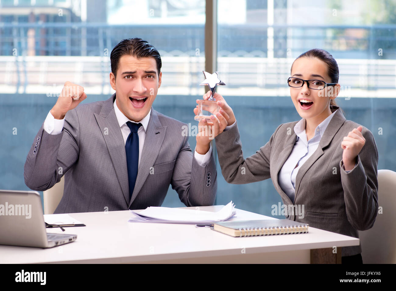 Businesspeople receiving award prize in office Stock Photo - Alamy
