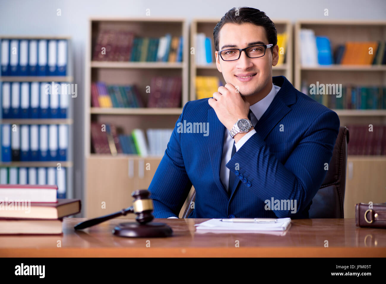Handsome judge with gavel sitting in courtroom Stock Photo - Alamy