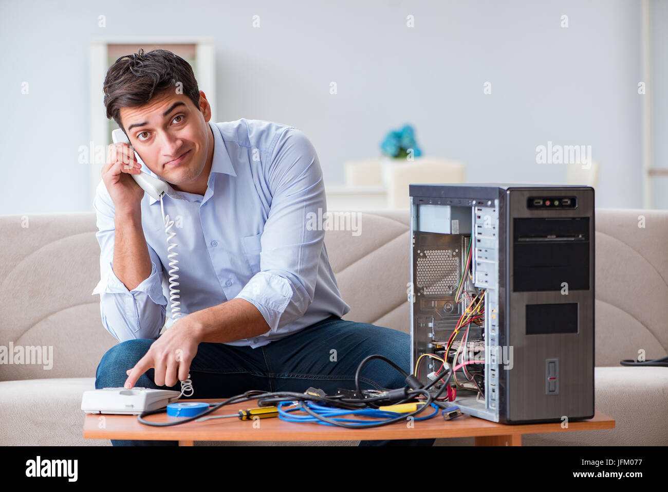 Angry customer trying to repair computer with phone support Stock Photo ...