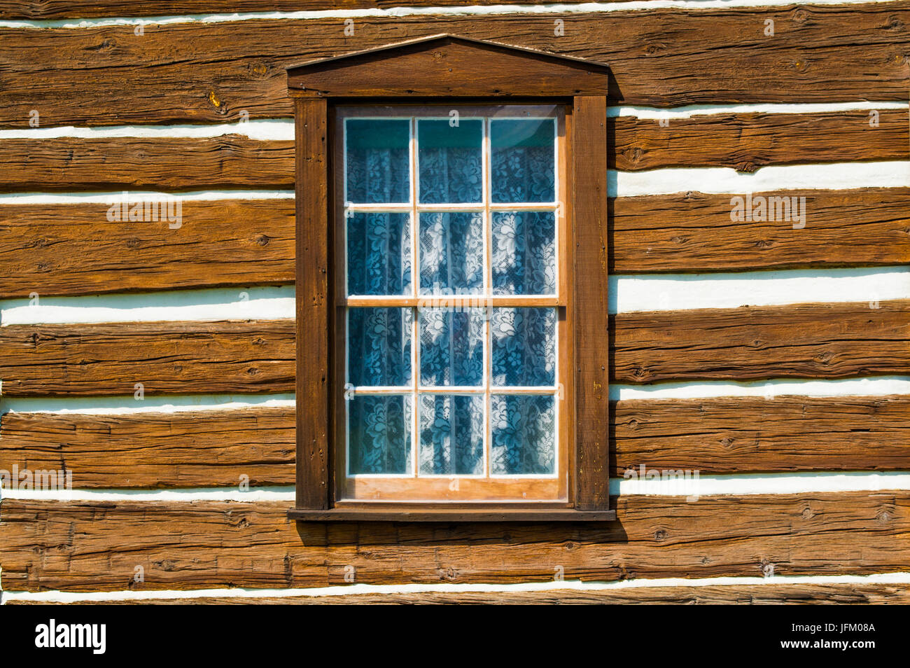 Rustic timber wall with window and lacy curtain in Montana Stock Photo ...