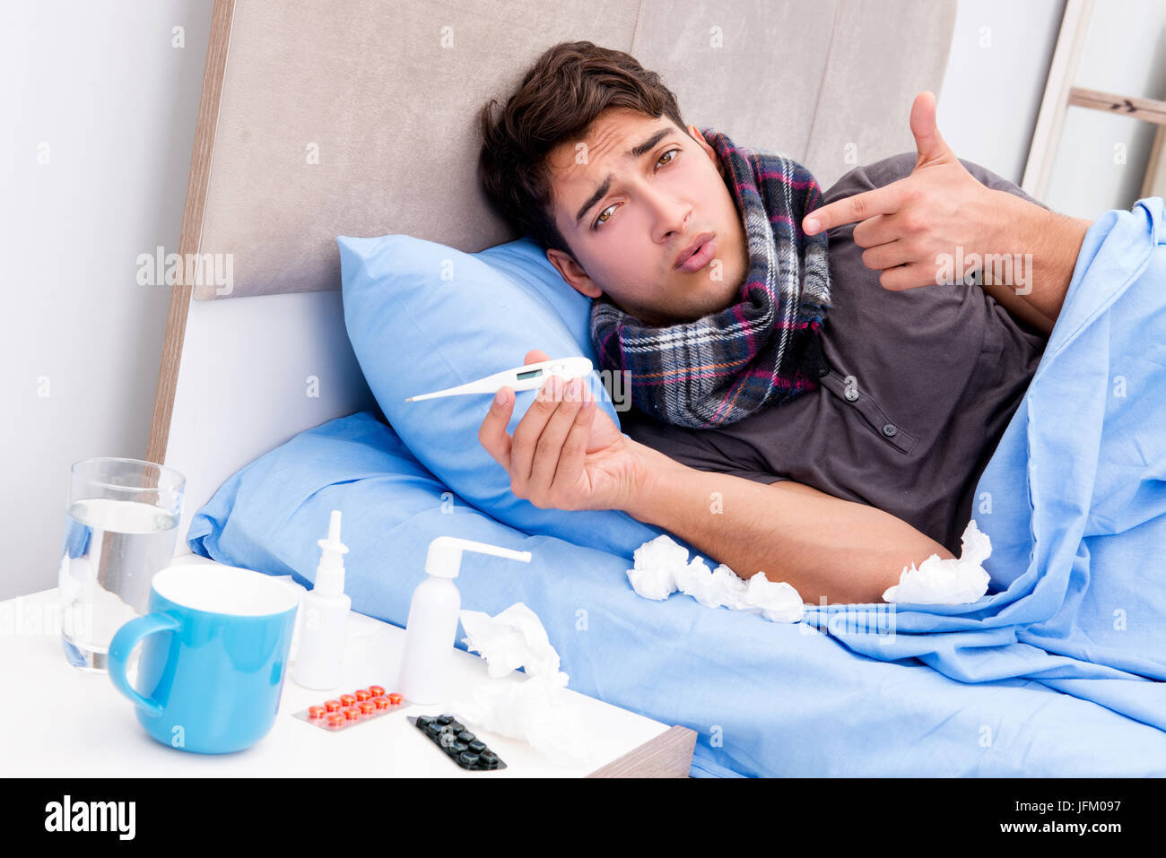 Sick ill man in the bed taking medicines and drugs Stock Photo - Alamy