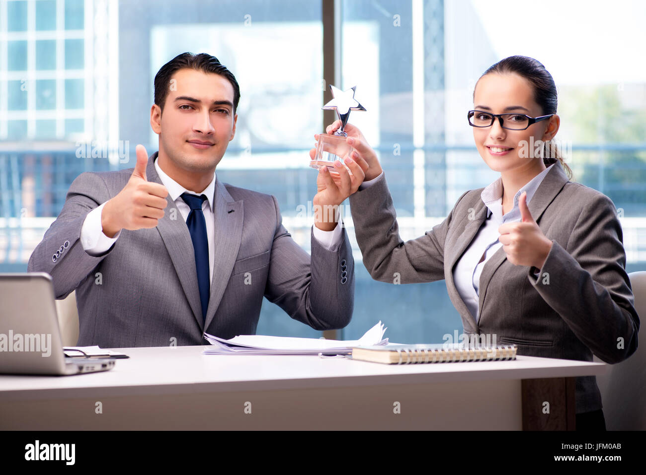 Businesspeople receiving award prize in office Stock Photo - Alamy